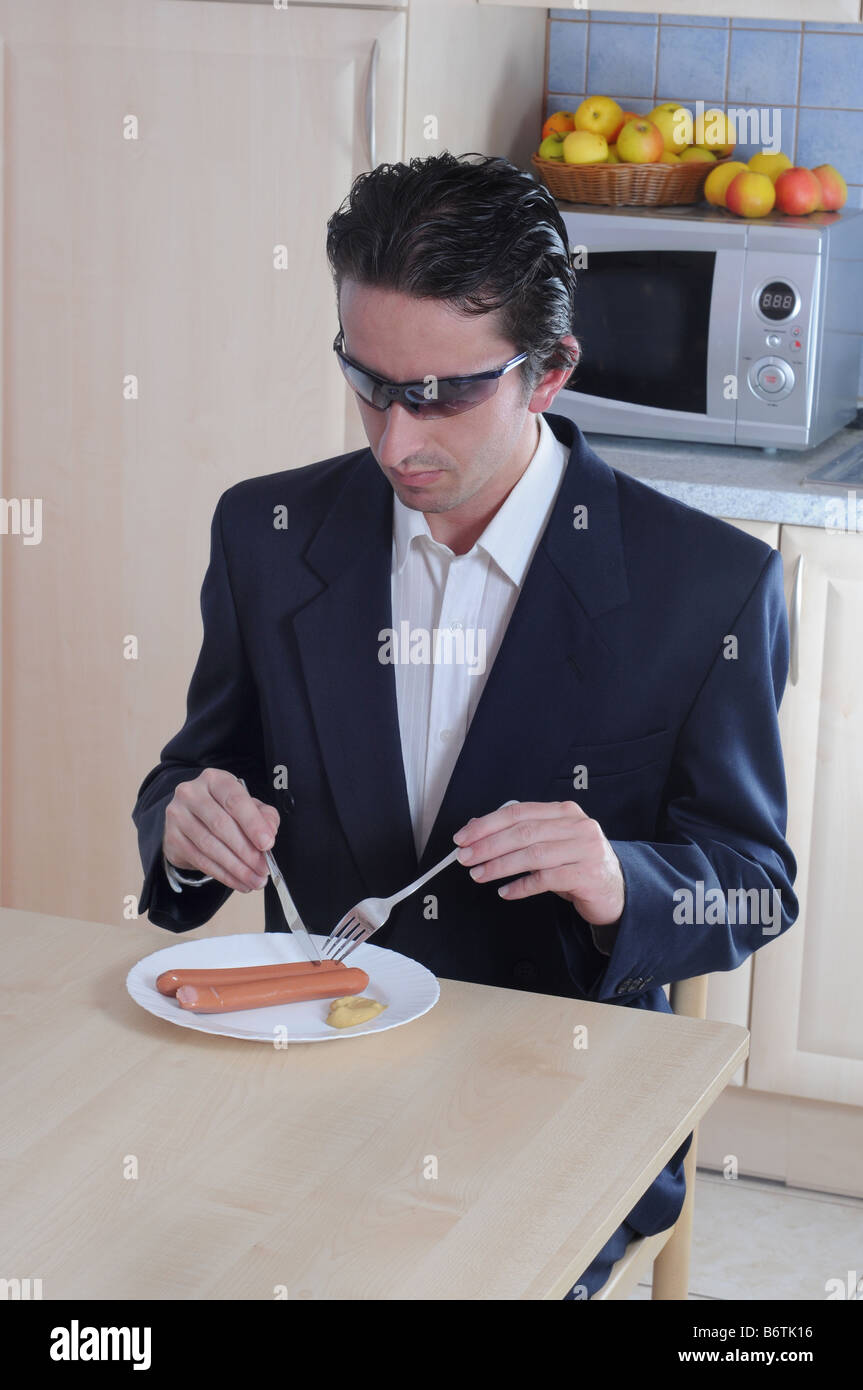 Lonely young man eating a poor dinner Stock Photo - Alamy