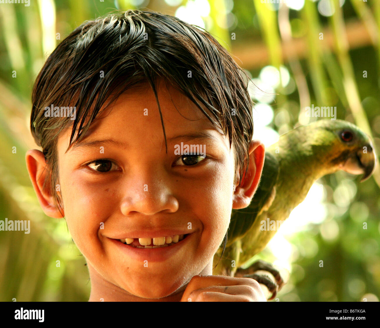 A smiling boy with his pet parrot Stock Photo - Alamy