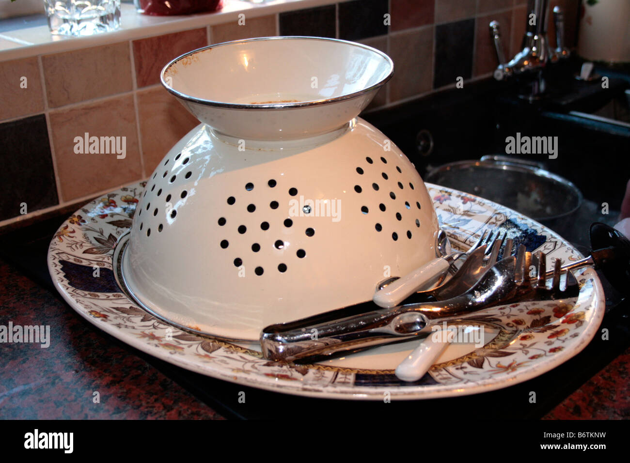 A colander and kitchen utensils Stock Photo - Alamy