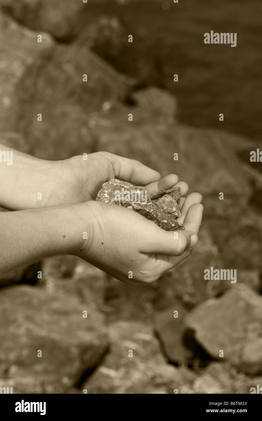 A childs hands holding rocks Stock Photo - Alamy