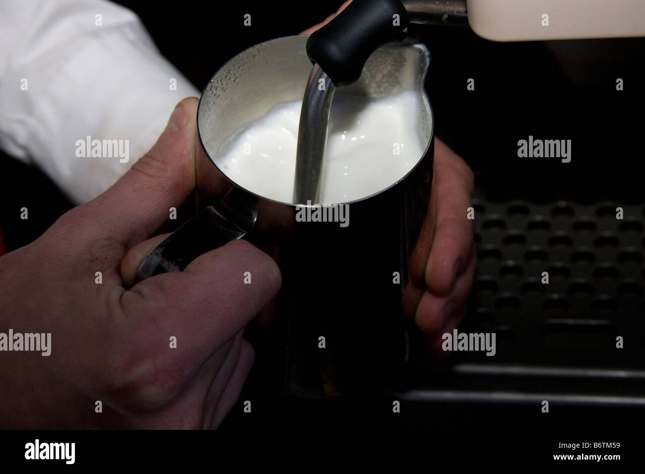 Heating the milk Stock Photo - Alamy