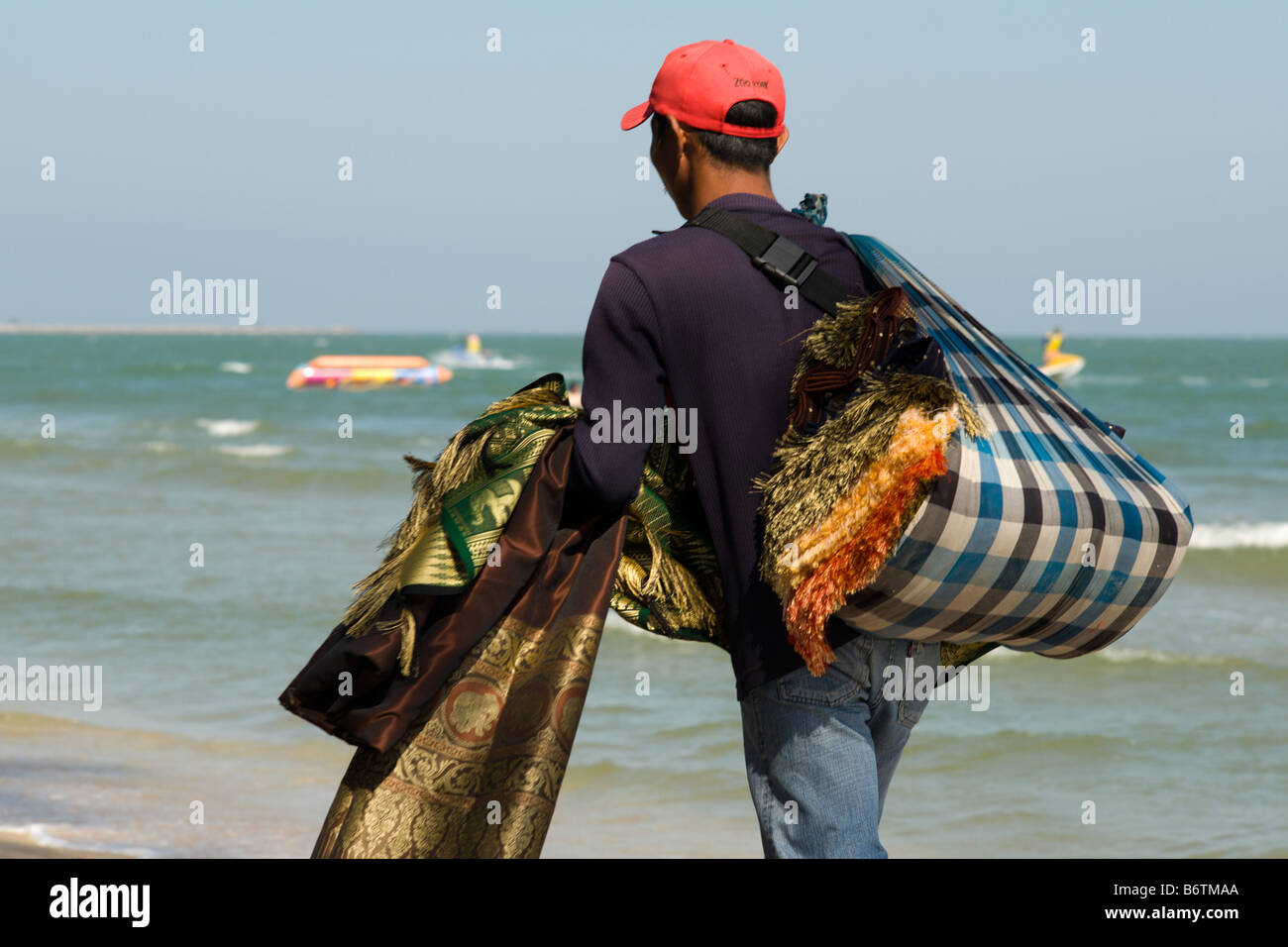 Man selling cloth on the beach in Thailand Stock Photo - Alamy