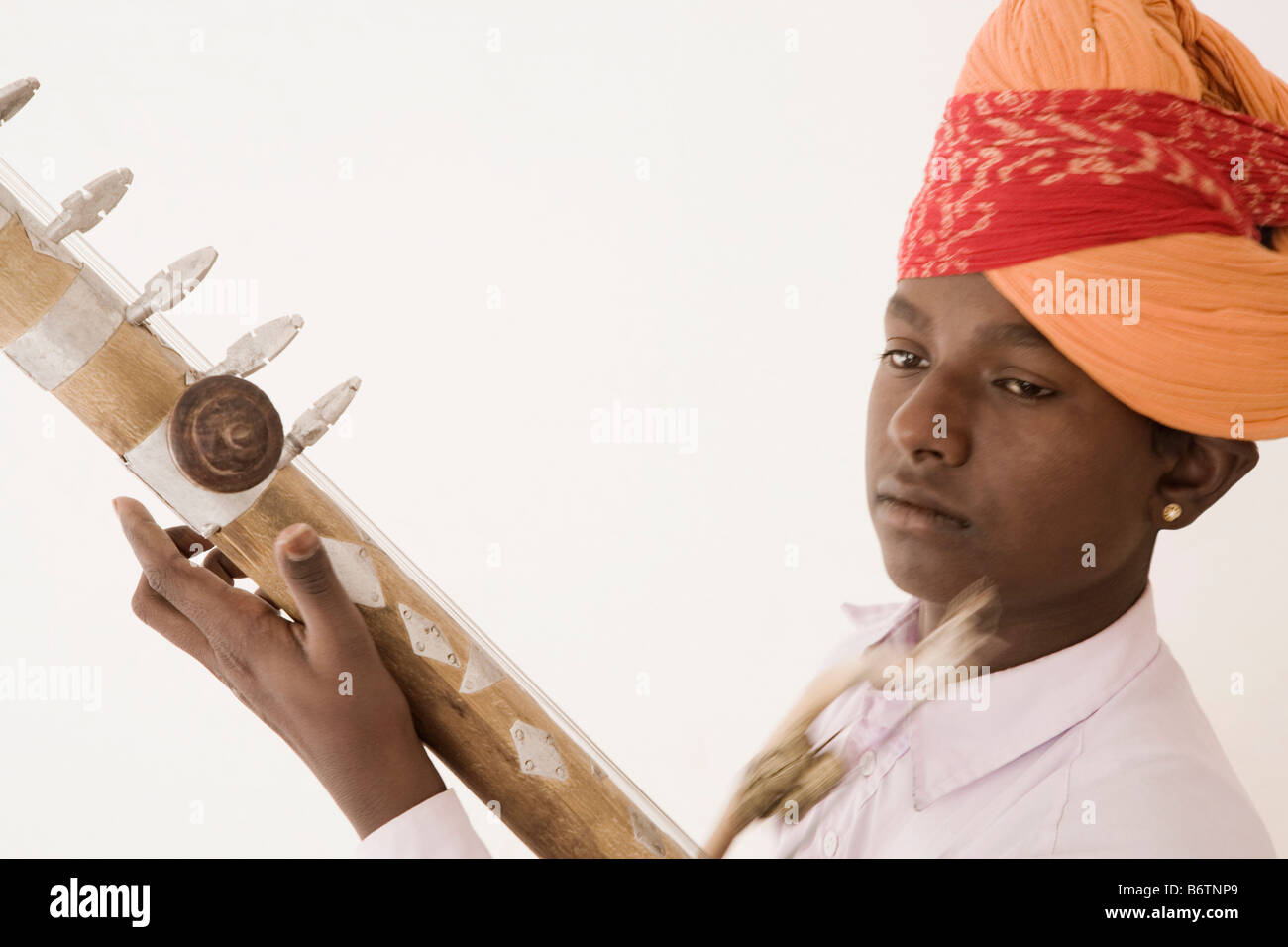 Close-up of a boy playing a musical instrument Stock Photo - Alamy