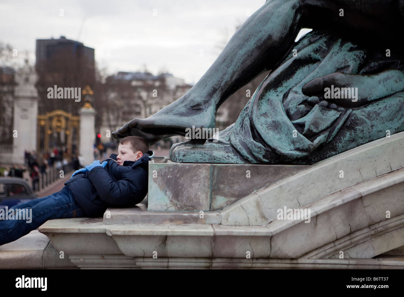 a child standing at the foot of a statue Stock Photo - Alamy