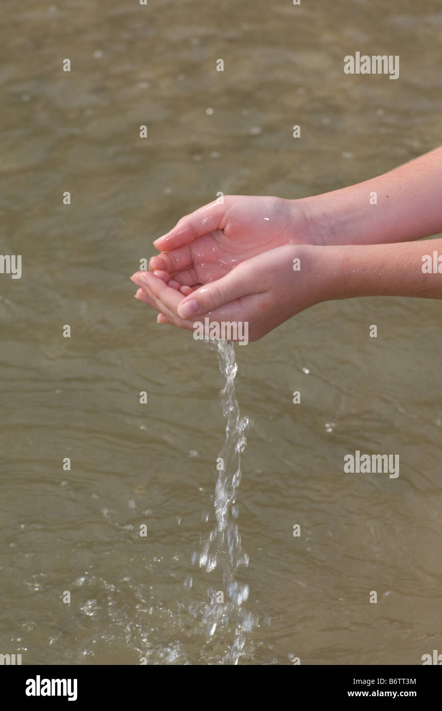 Water passing through a childs hands at beach Stock Photo - Alamy