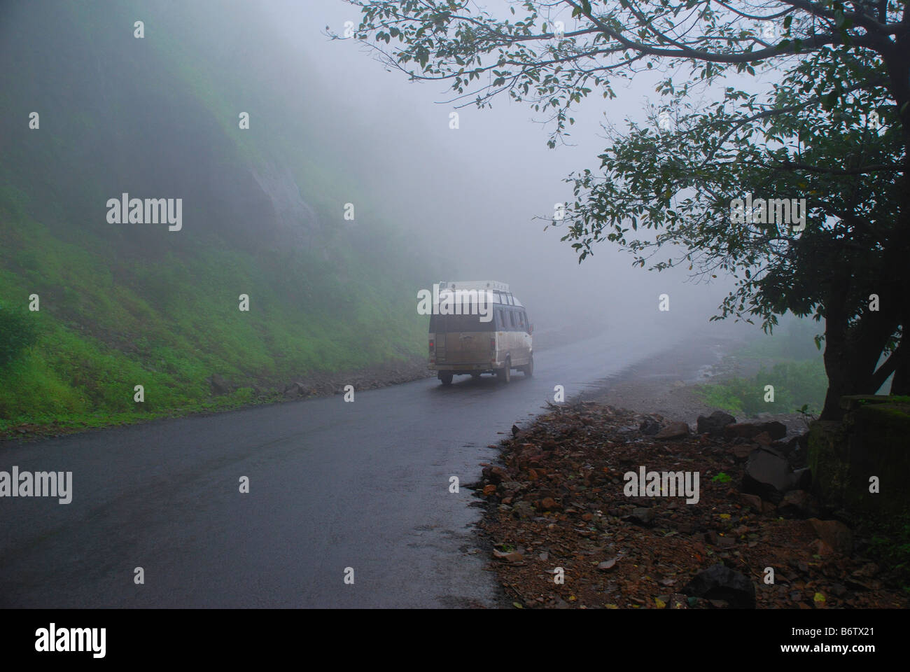 Bus traveling on road, during rainy season, Mulshi Ghat, Maharashtra ...