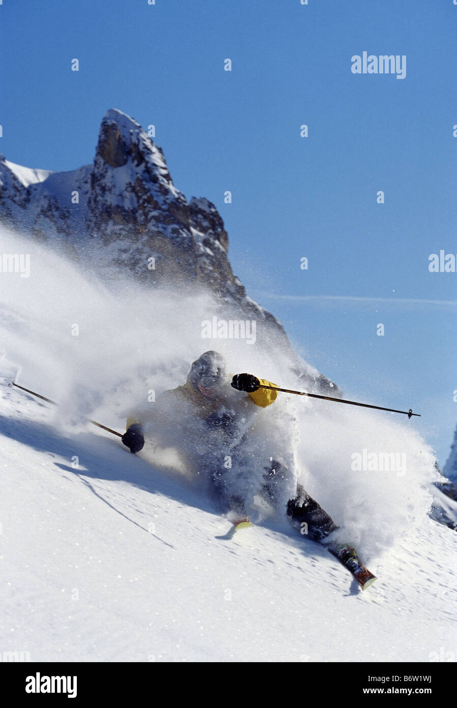 Skier descending a steep slope hi-res stock photography and images - Alamy