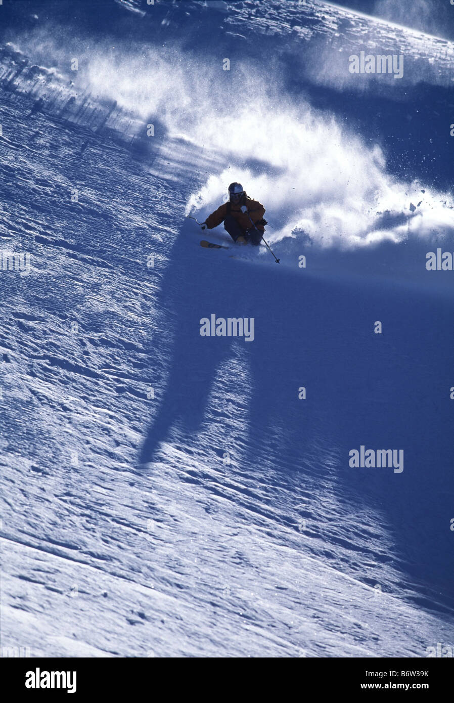Skier descending a steep slope hi-res stock photography and images - Alamy