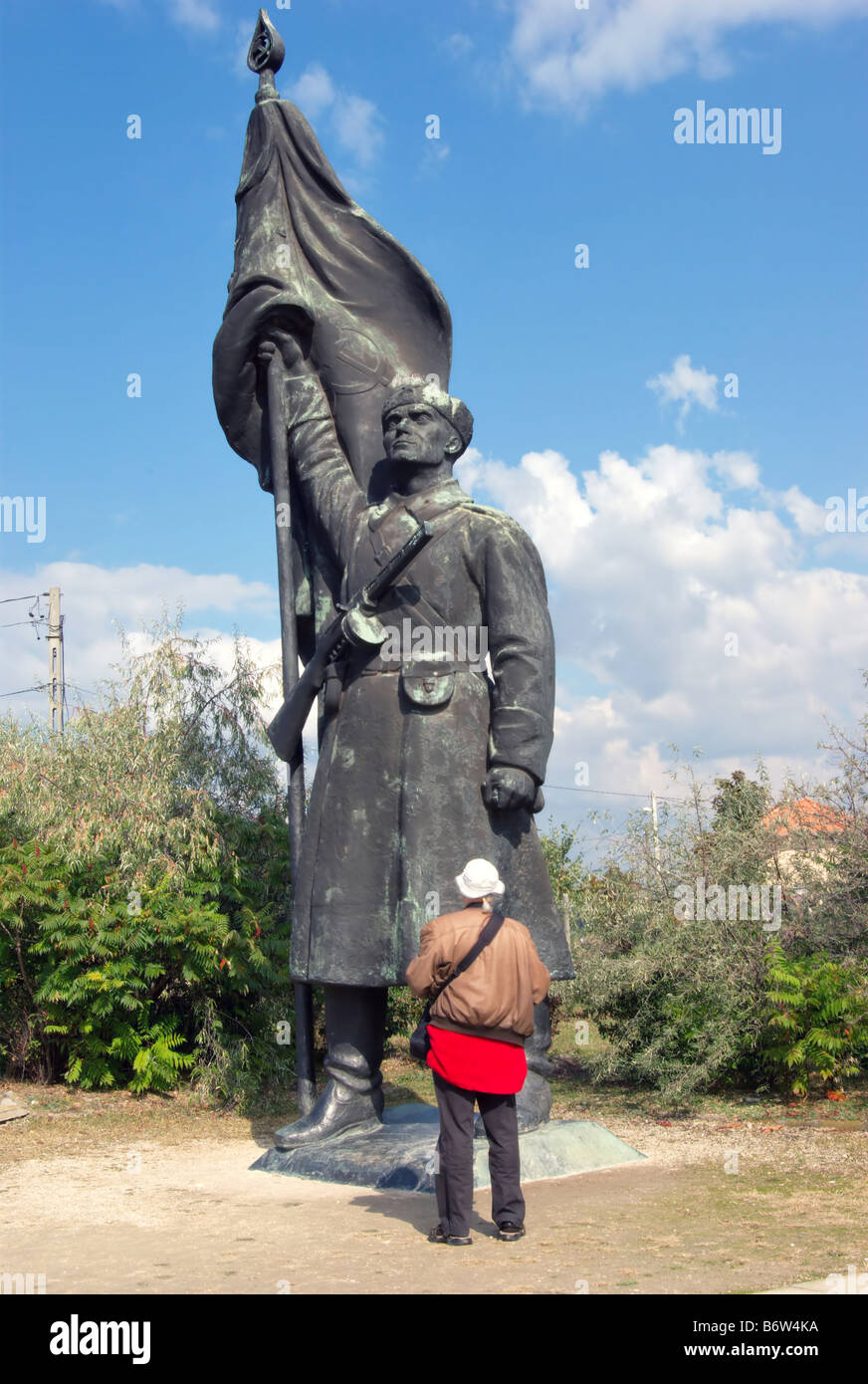 Oversized statue of Soviet soldier with machine gun and flag Stock ...