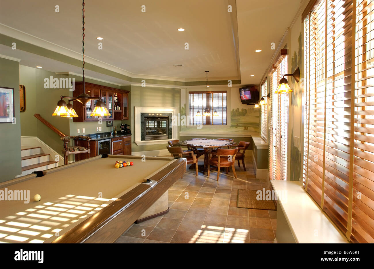 Traditional game room with pool and poker table Stock Photo - Alamy