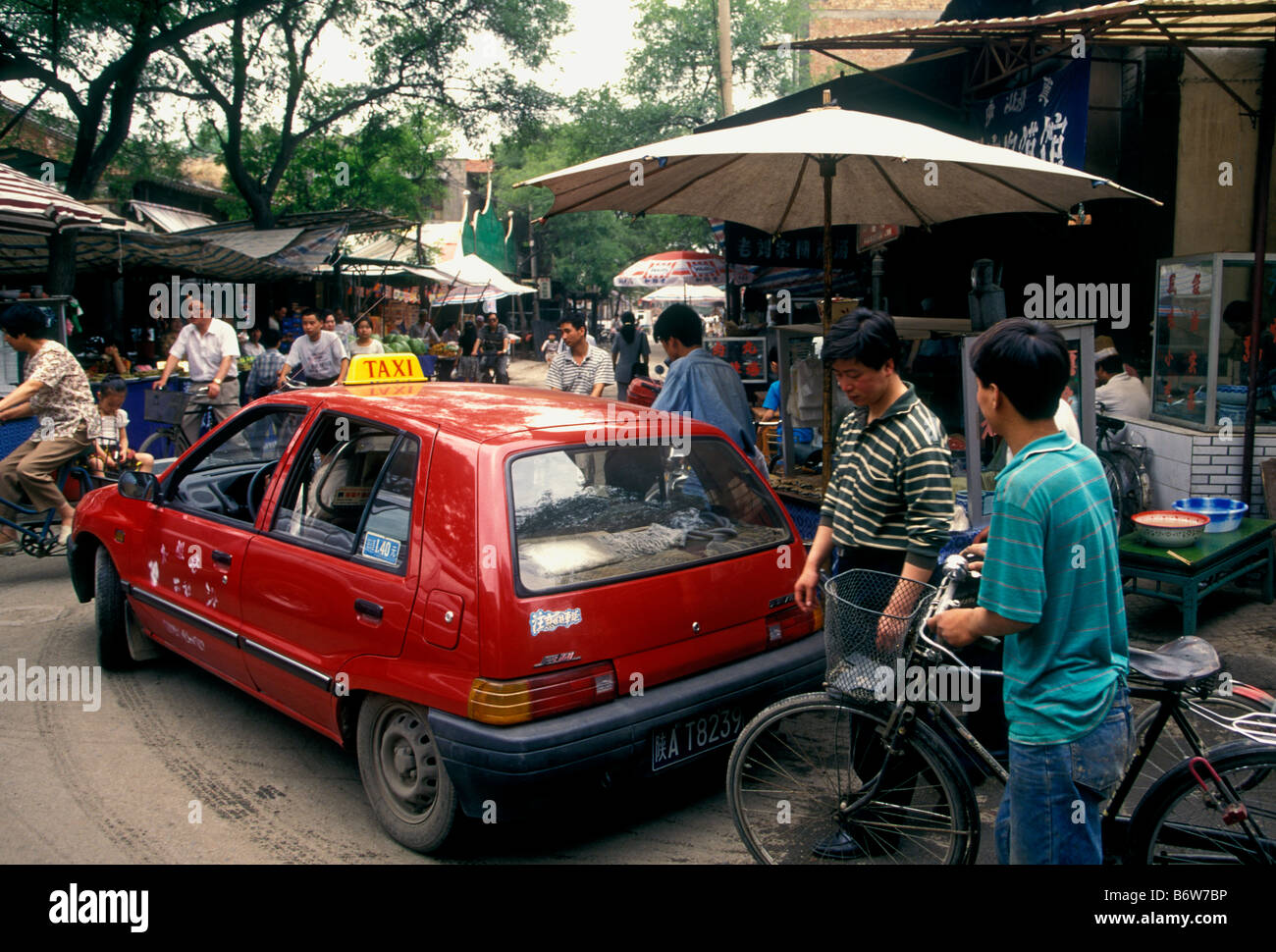 red taxicab taxi driver taxi ride in narrow street in the Muslim ...
