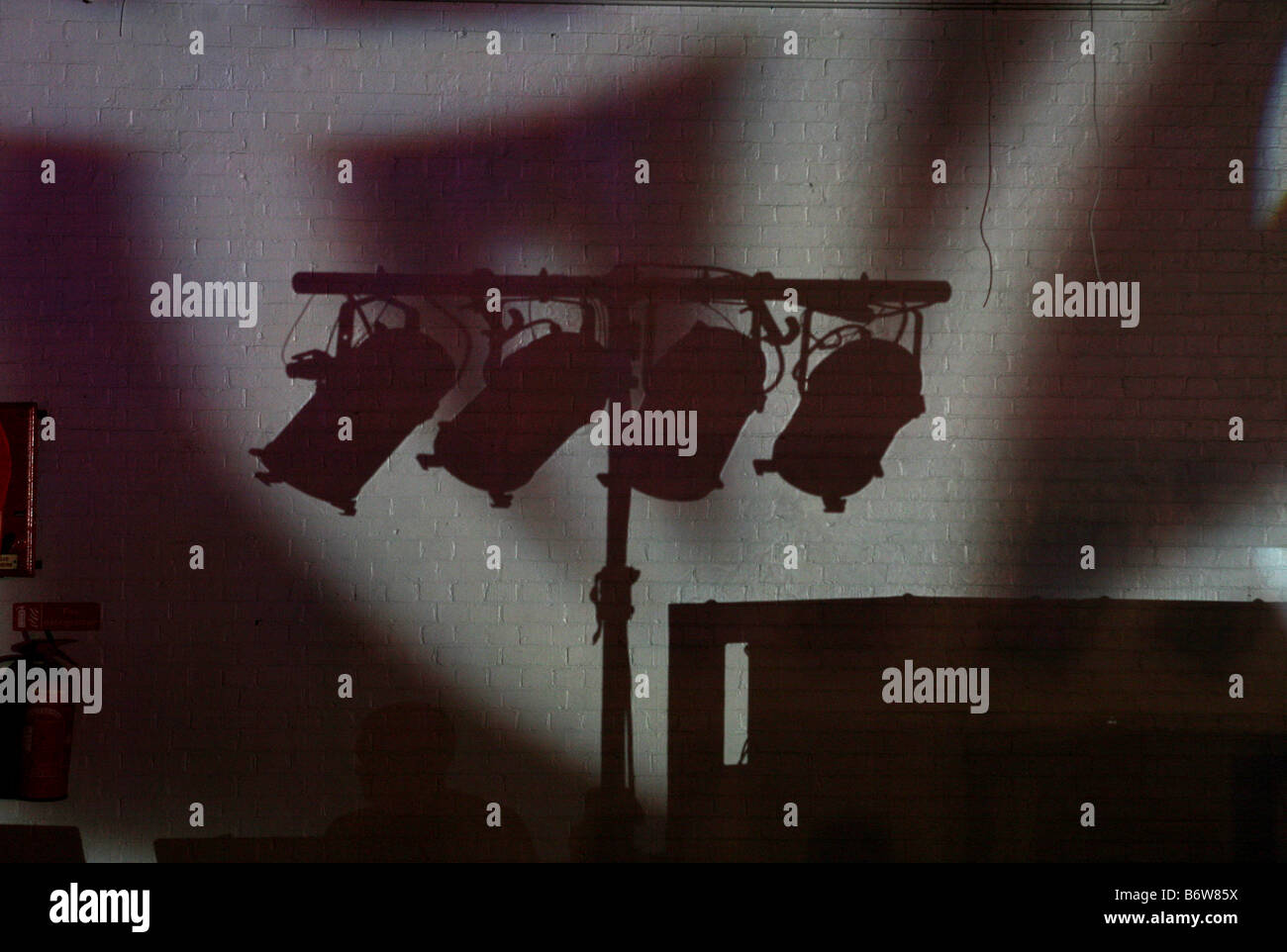 Shadows of stage lights on a white brick wall Stock Photo - Alamy