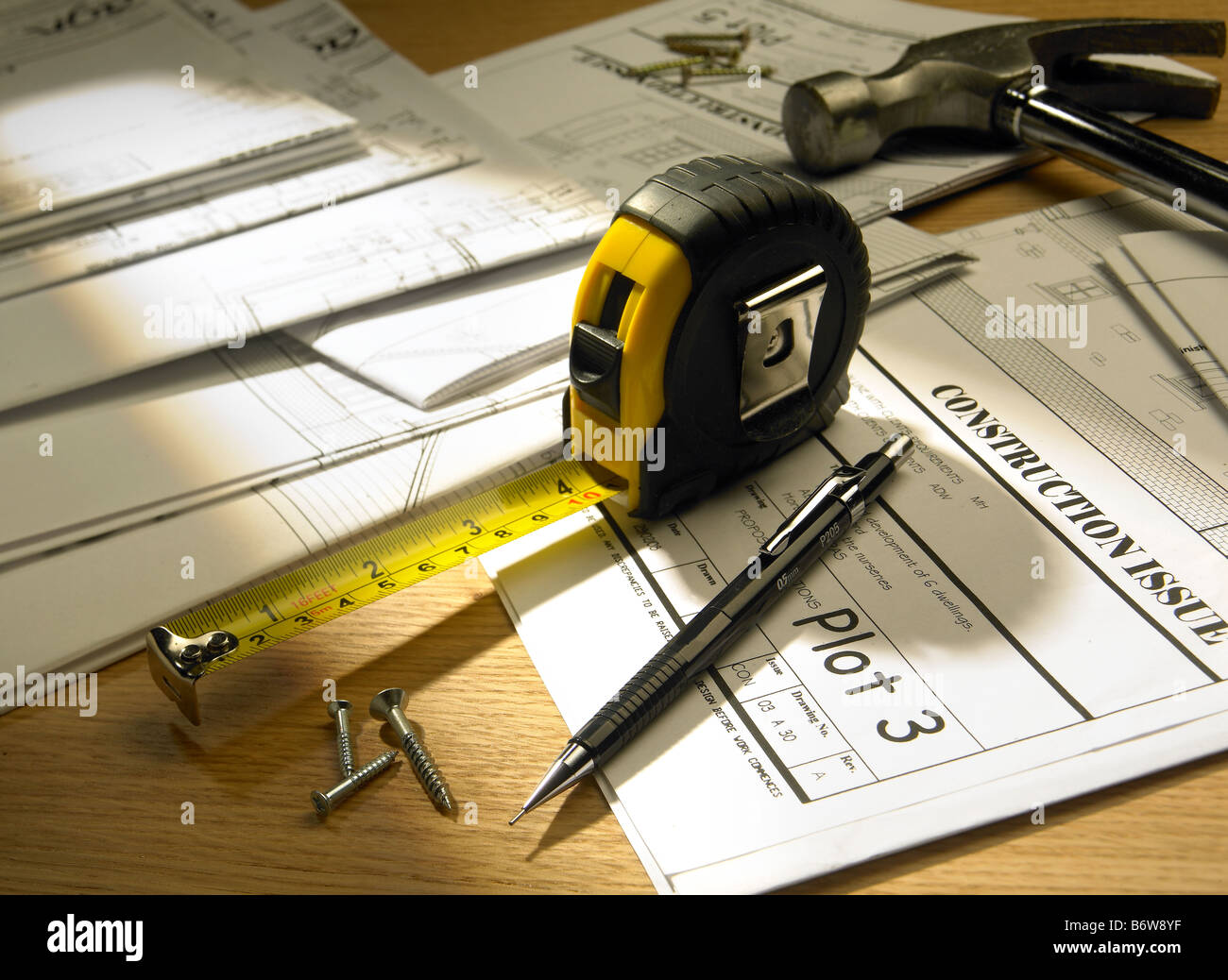 Building plans with tape measure and hammer Stock Photo - Alamy