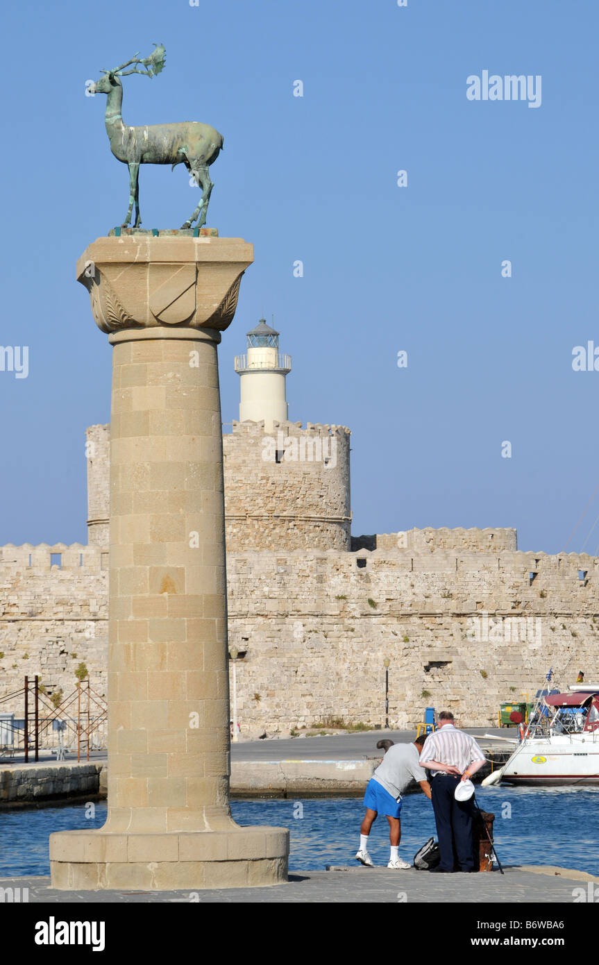 Local men fishing at Mandraki Harbour Entrance Rhodes Greece Stock ...