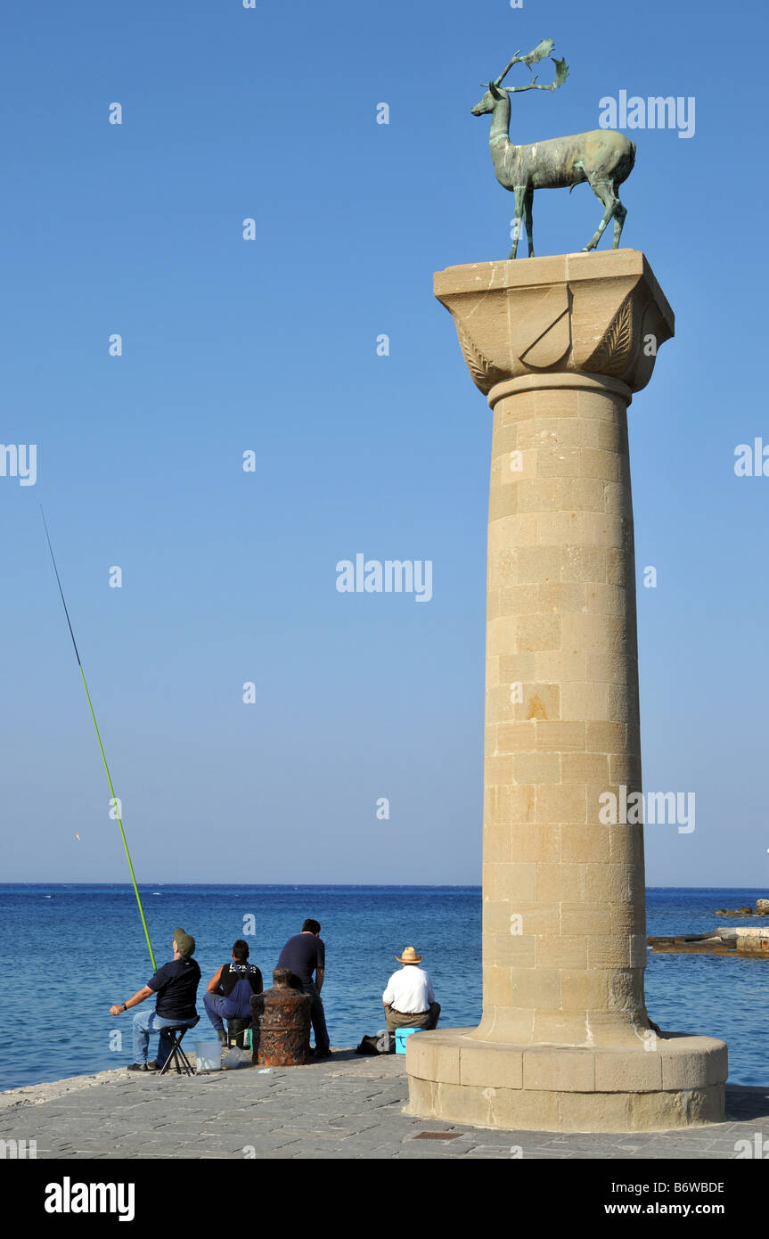 Local men fishing at Mandraki Harbour Entrance Rhodes Greece Stock ...