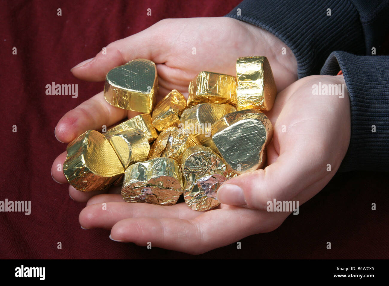 Hands with chocolates Stock Photo - Alamy
