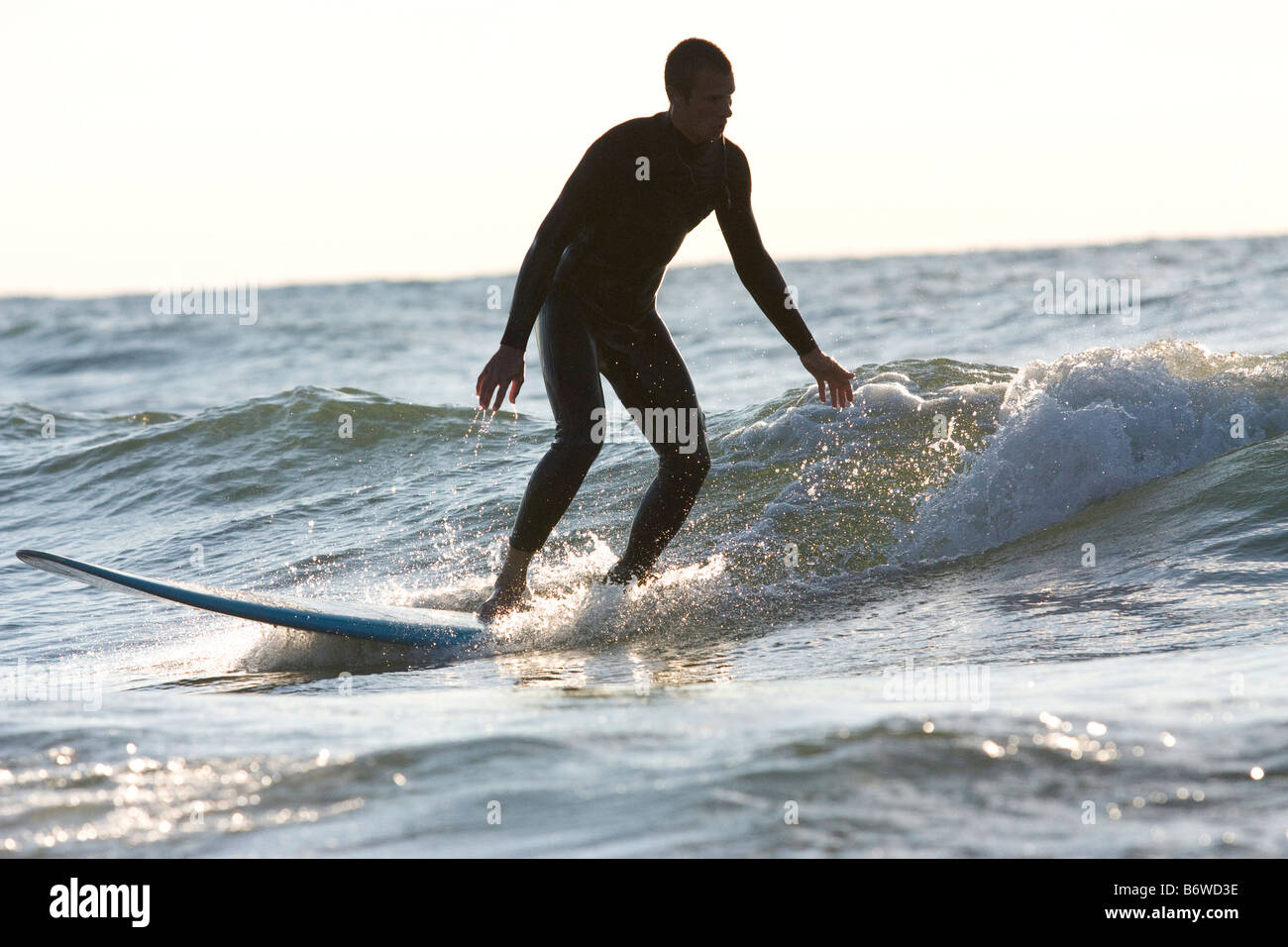 Surfer skillfully riding a small wave on Lake Michigan Stock Photo - Alamy