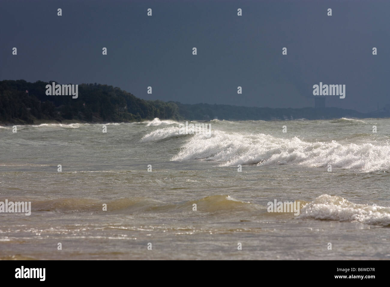 Large swell waves rolling in towards beach on Lake Michigan Stock Photo ...
