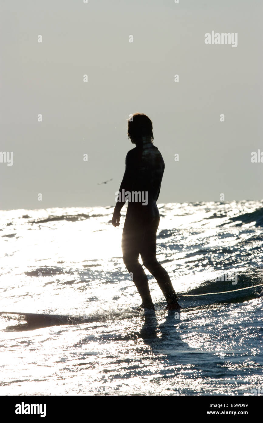 Surfer standing on a board at the end of a ride in Lake Michigan Stock ...