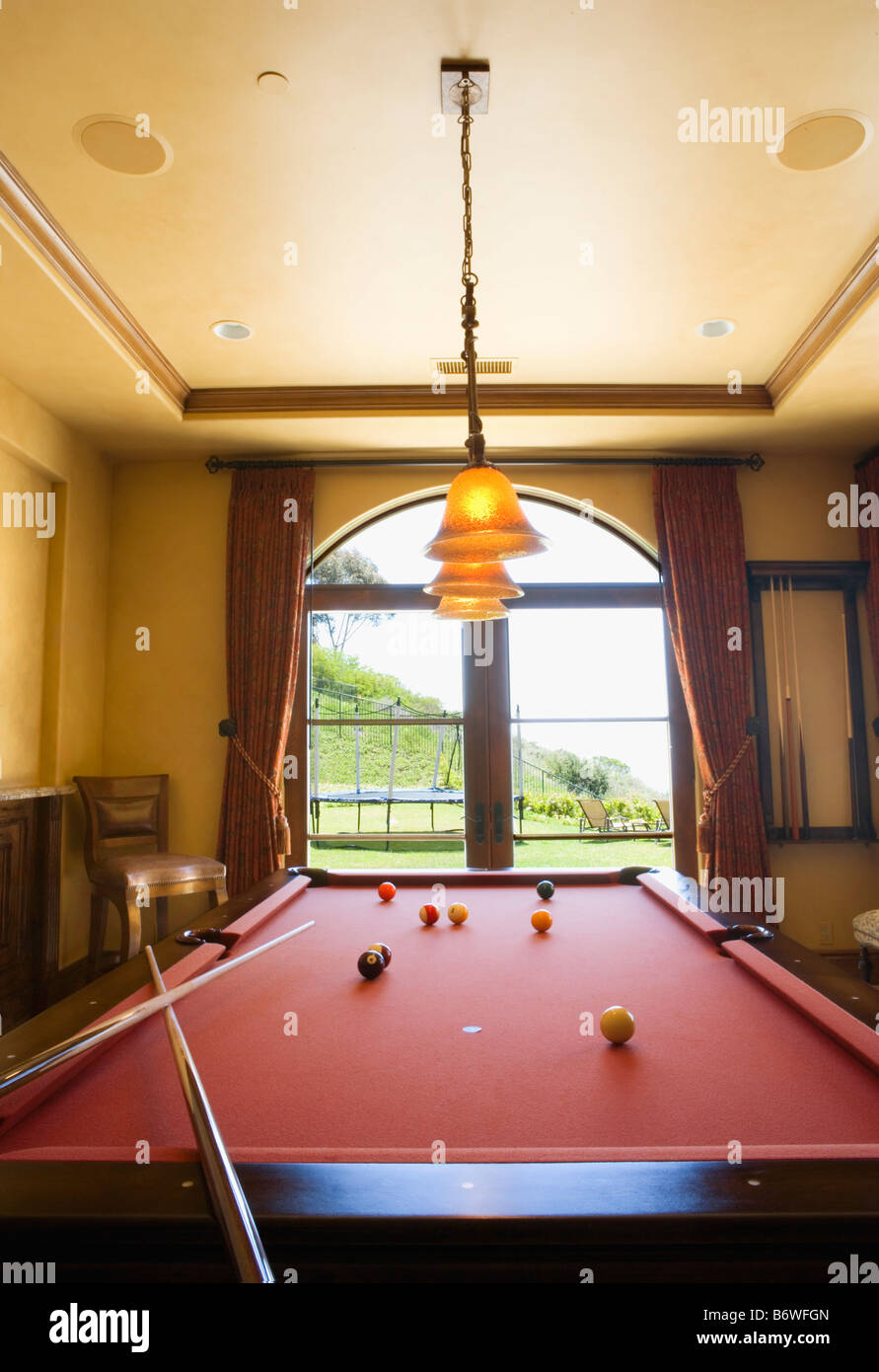 Red Pool Table and Balls with Overhead Lights and Window Stock Photo ...