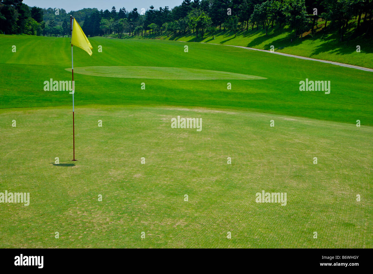 Yellow flag in golf course Stock Photo - Alamy