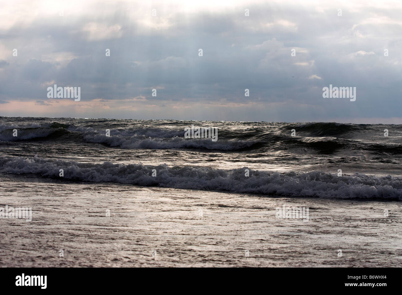 Large waves illuminated by the rays of the sun on Lake Michigan near ...