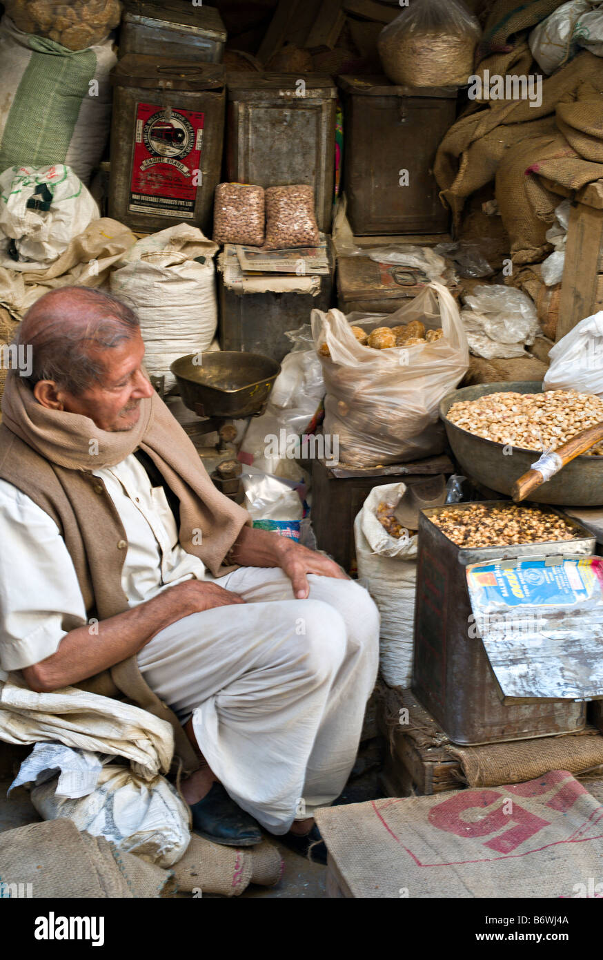 INDIA JAISALMER RAJASTHAN Indian merchant in his tiny shop in the ...