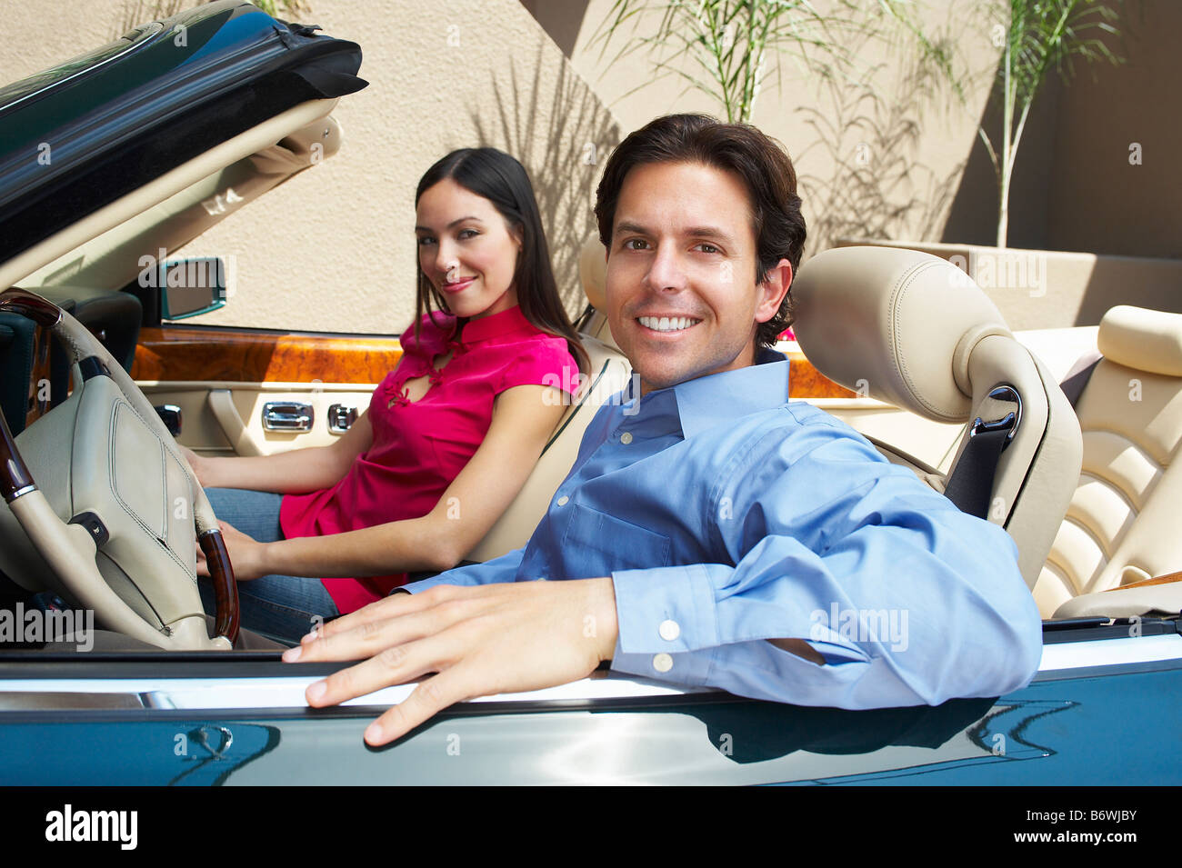 Couple Sitting in a Convertible Stock Photo - Alamy