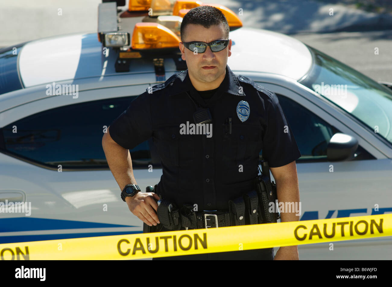 Police Officer Standing Behind Police Tape Stock Photo - Alamy