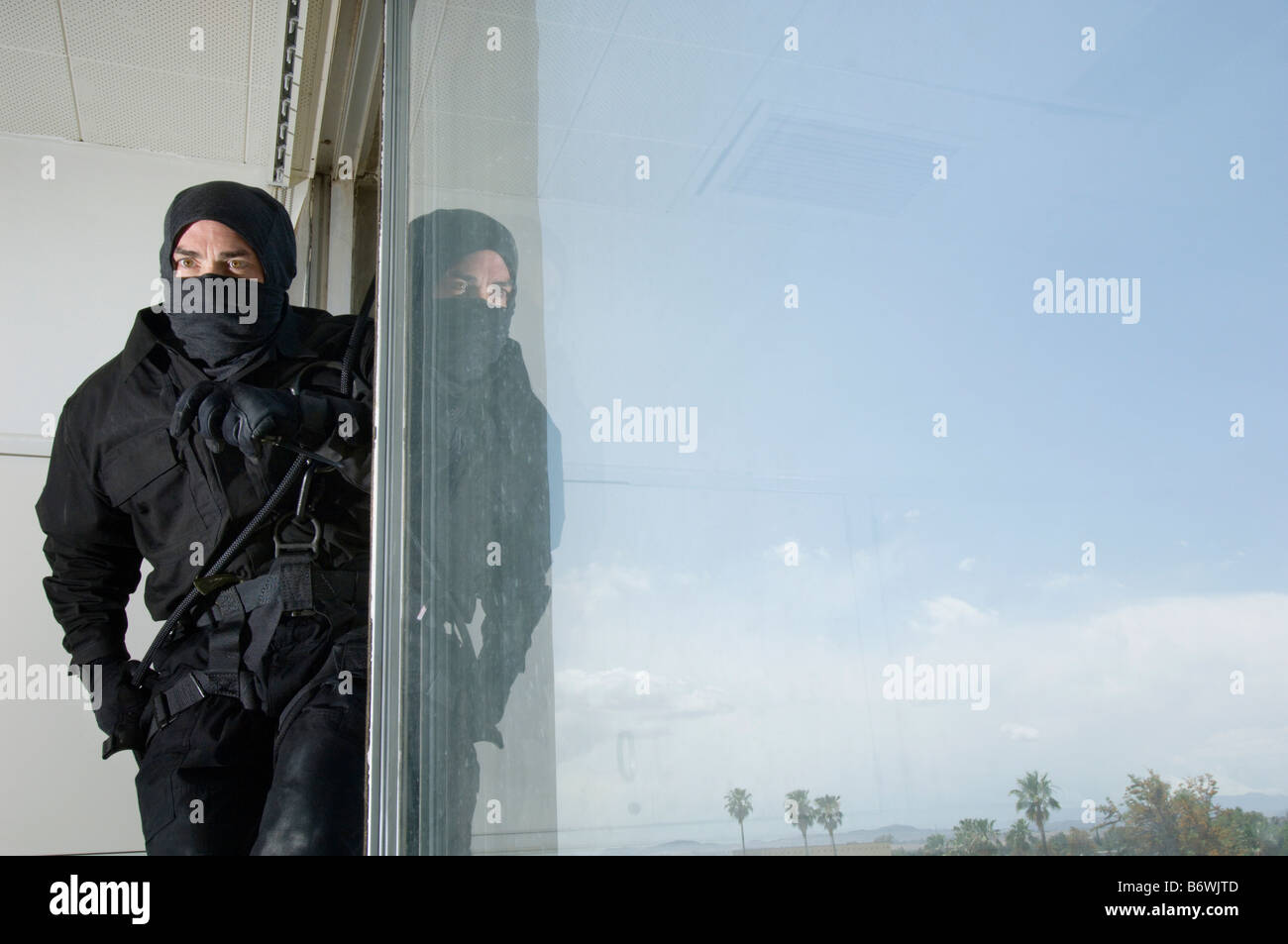 SWAT Team Officer in Window Stock Photo - Alamy