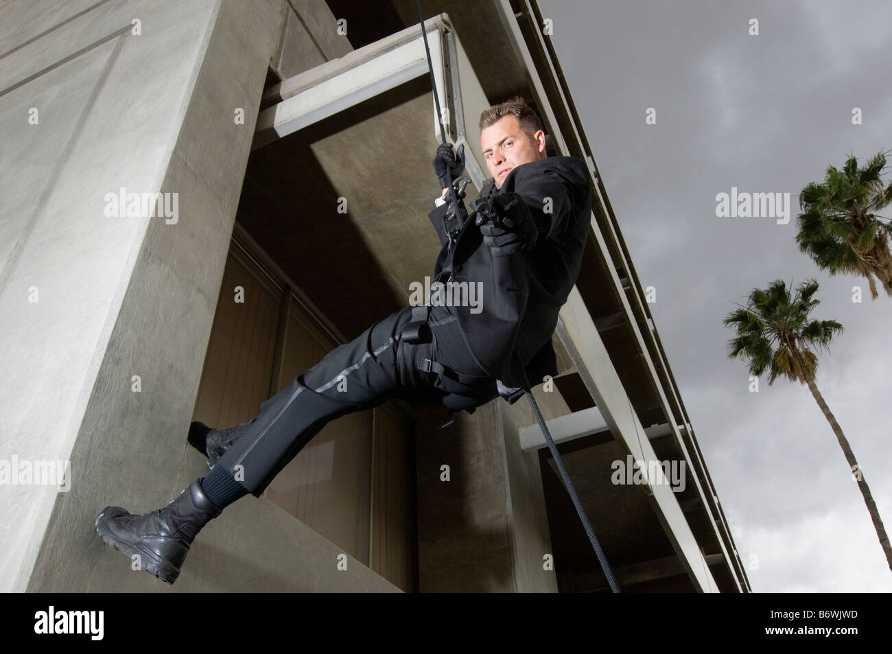 SWAT Team Officer Rappelling from Building Stock Photo - Alamy