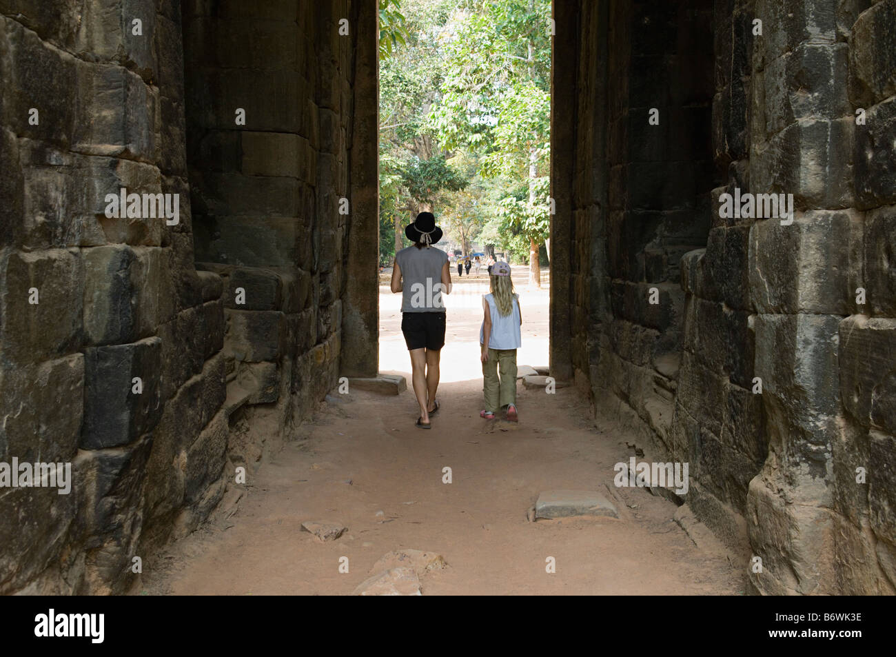 Woman and Girl Walking Through Passage in Ancient Building Stock Photo ...