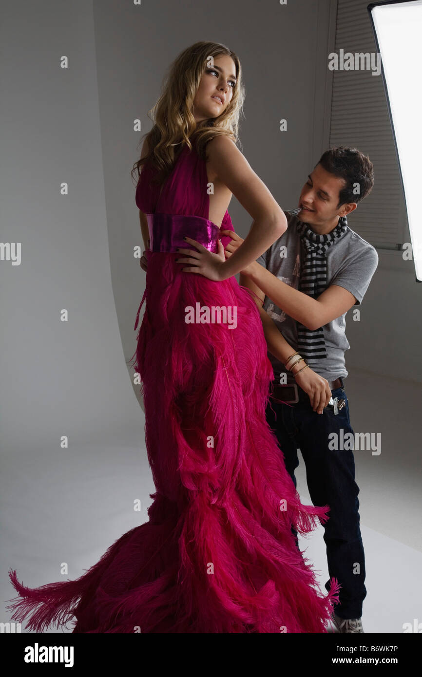 Designer Adjusting Dress Back on Fashion Model Stock Photo - Alamy