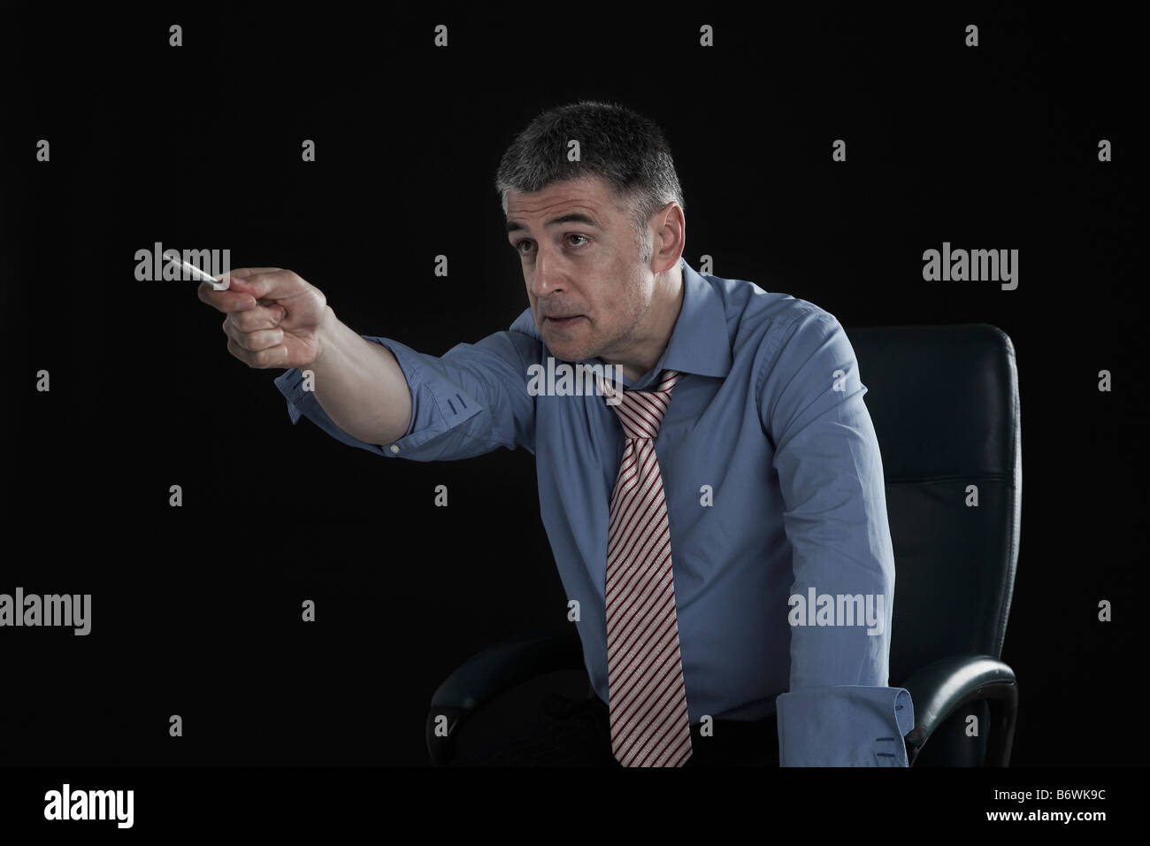 Angry Businessman Pointing a Pen Stock Photo - Alamy