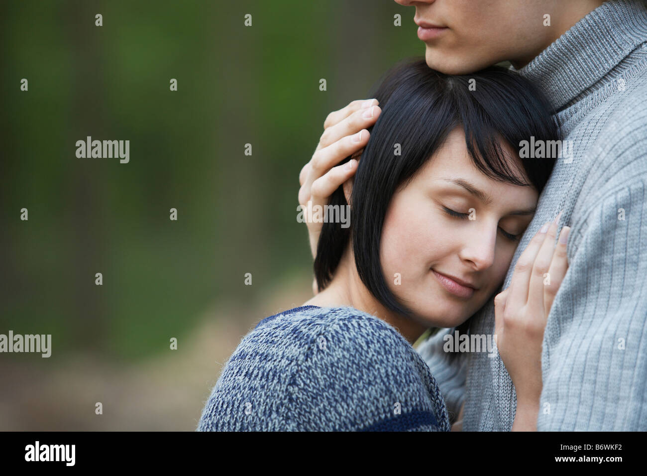 Young Woman Laying Head on Chest of Young Man Stock Photo - Alamy