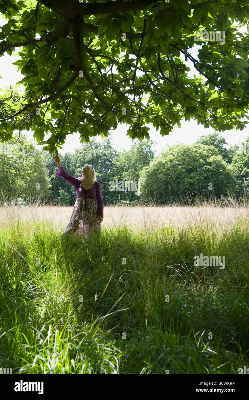 Woman Standing Beneath a Tree Stock Photo - Alamy
