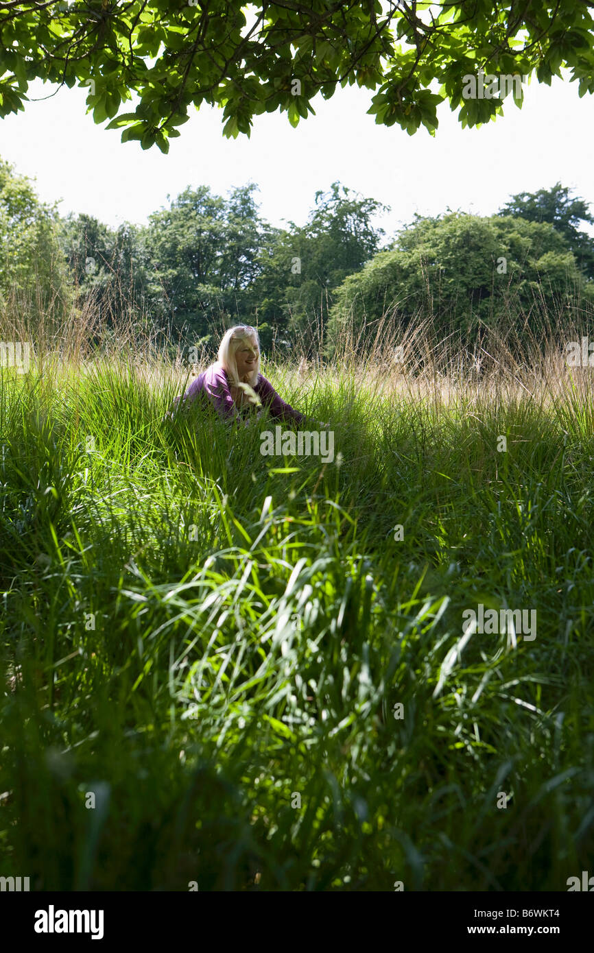 Woman Sitting in the Shade of a Tree Stock Photo - Alamy
