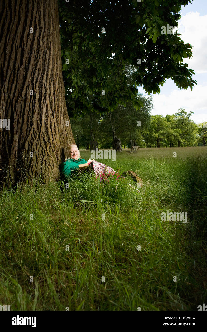 Woman Sitting Beneath a Tree Stock Photo - Alamy