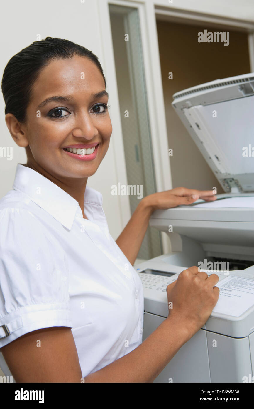 Businesswoman Using Photocopier Stock Photo - Alamy