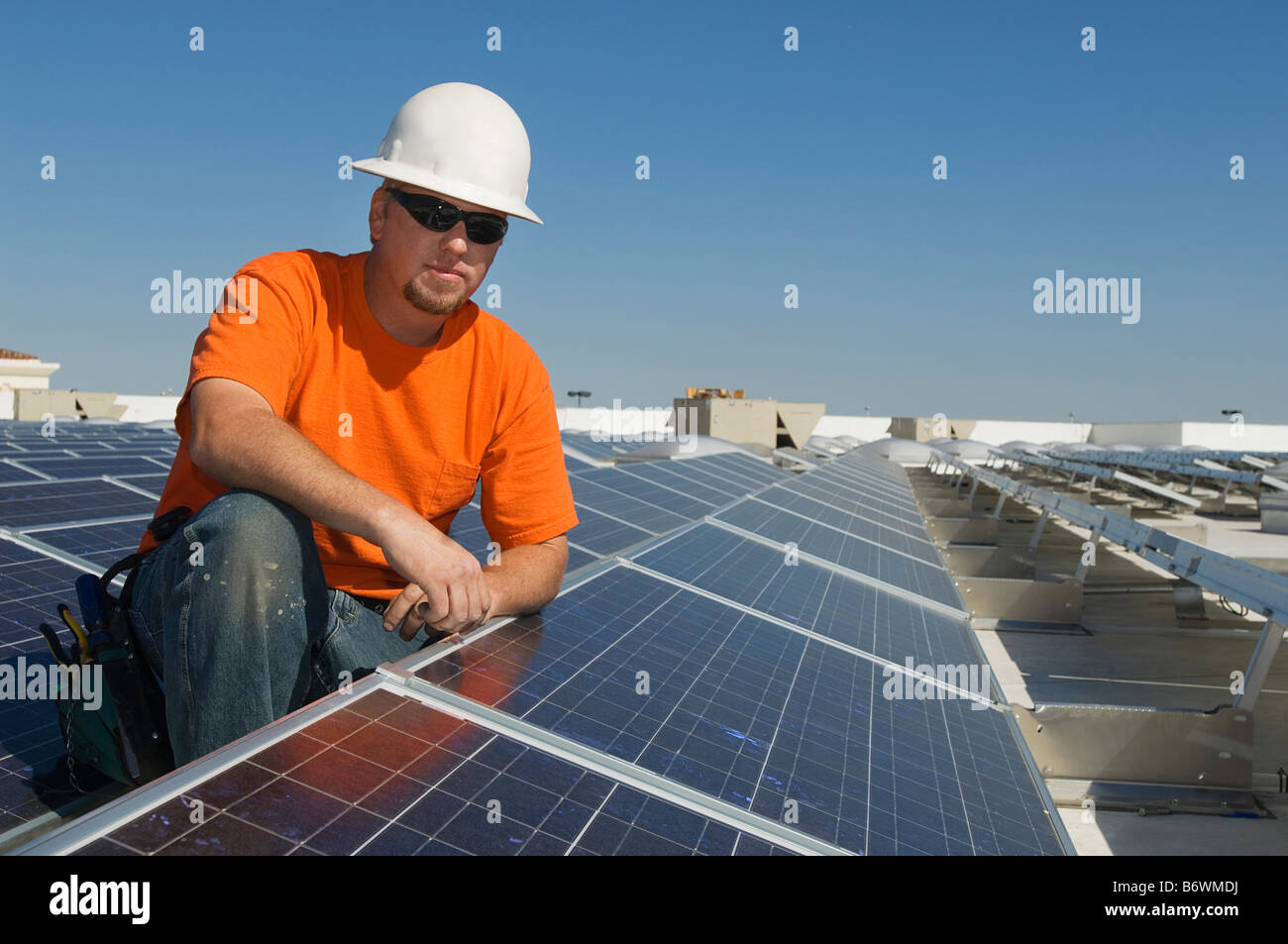 Electrical Engineer Among Solar Panels at Solar Power Plant Stock Photo ...