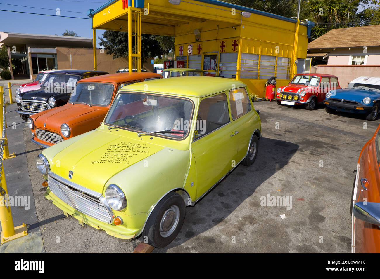 Old Mini's sitting on garage forecourt Stock Photo - Alamy