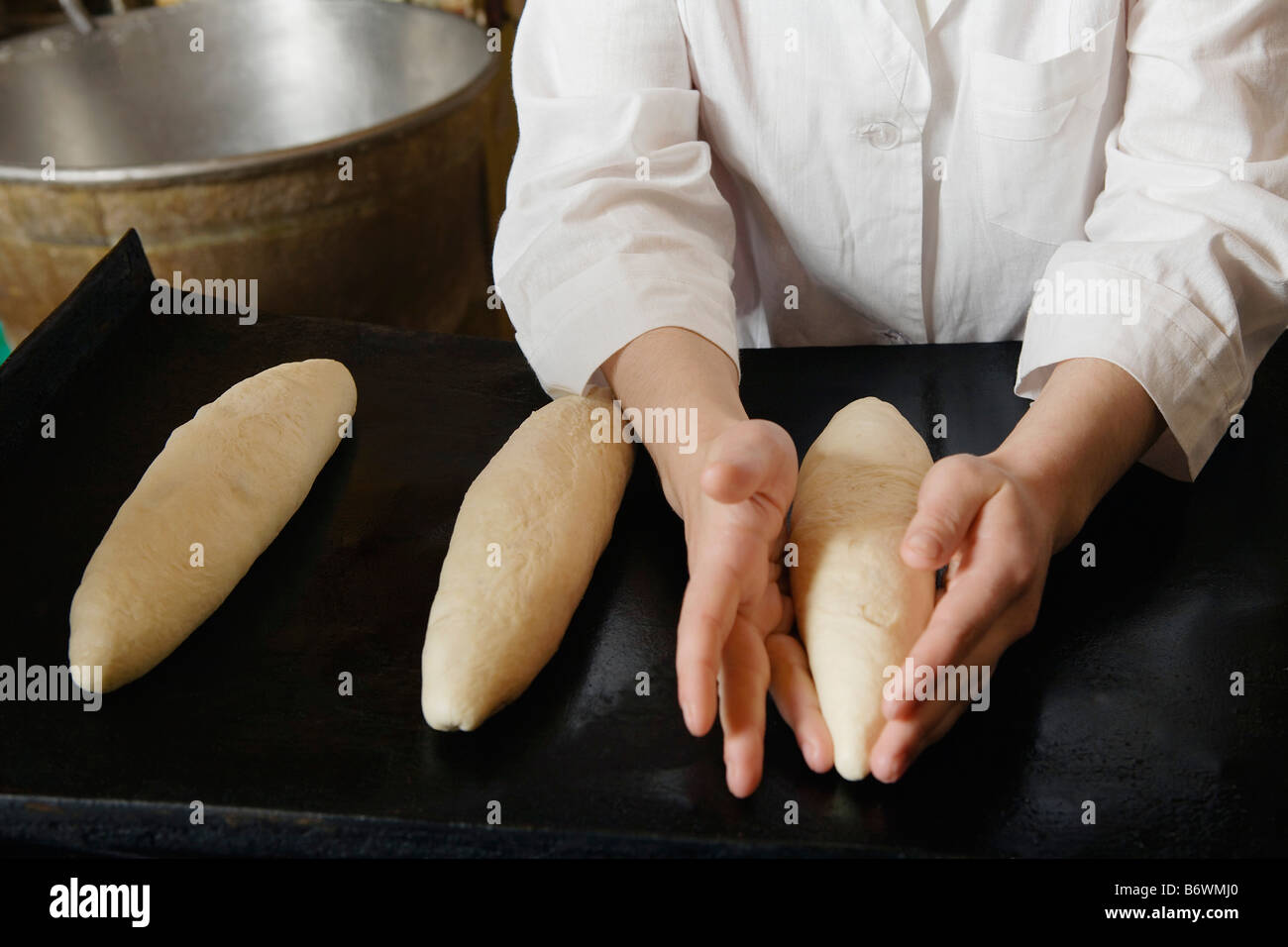 Baker Shaping Loaves of Bread Dough Stock Photo - Alamy