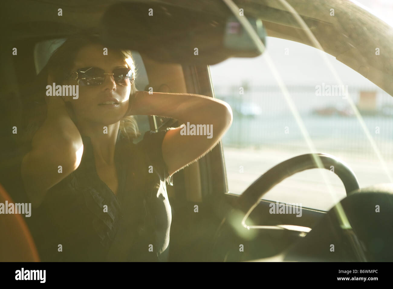 Glare on windscreen of woman's car Stock Photo - Alamy