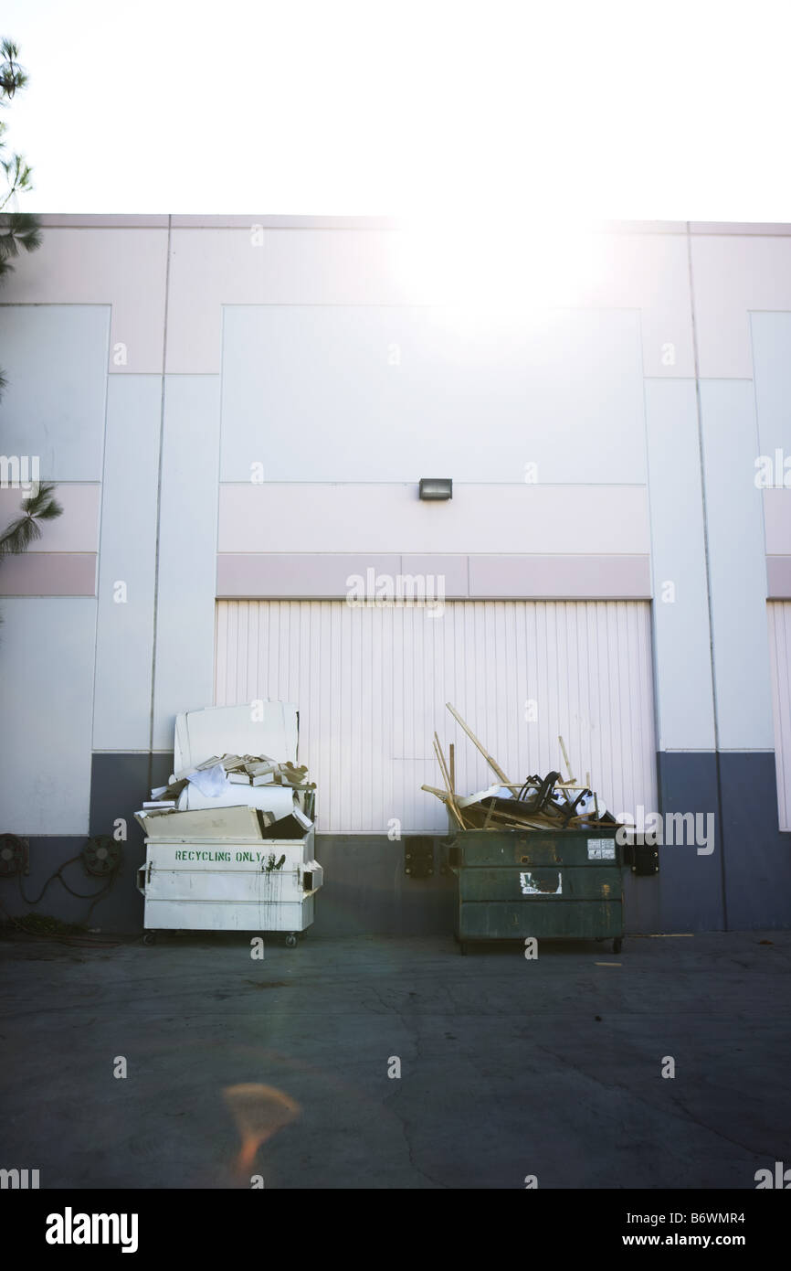 Trash and recycling dumpsters outside warehouse Stock Photo - Alamy