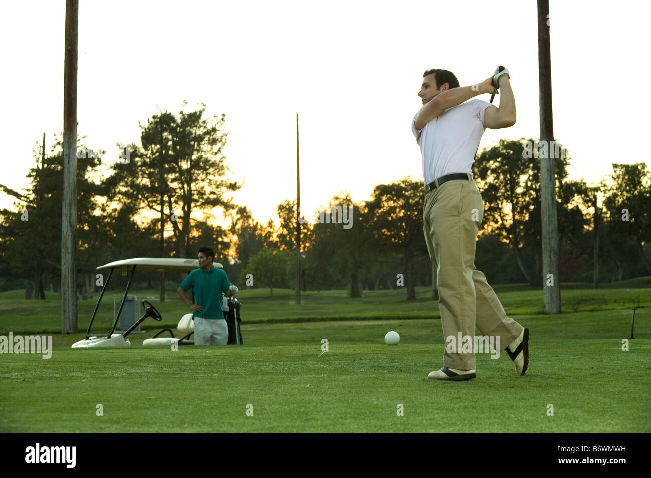 Men playing golf Stock Photo - Alamy