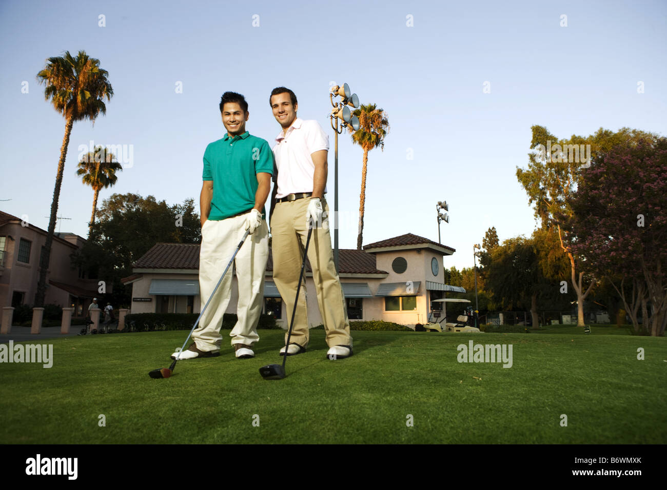 Two men playing golf Stock Photo - Alamy
