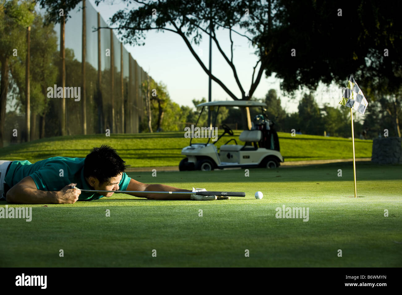 Man pretending to play snooker on golf course Stock Photo - Alamy