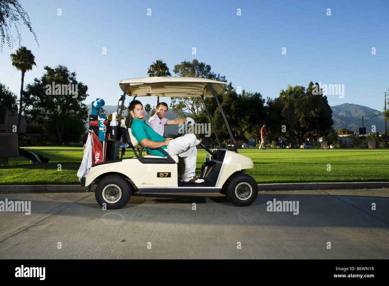 Two golfers on golf cart Stock Photo - Alamy