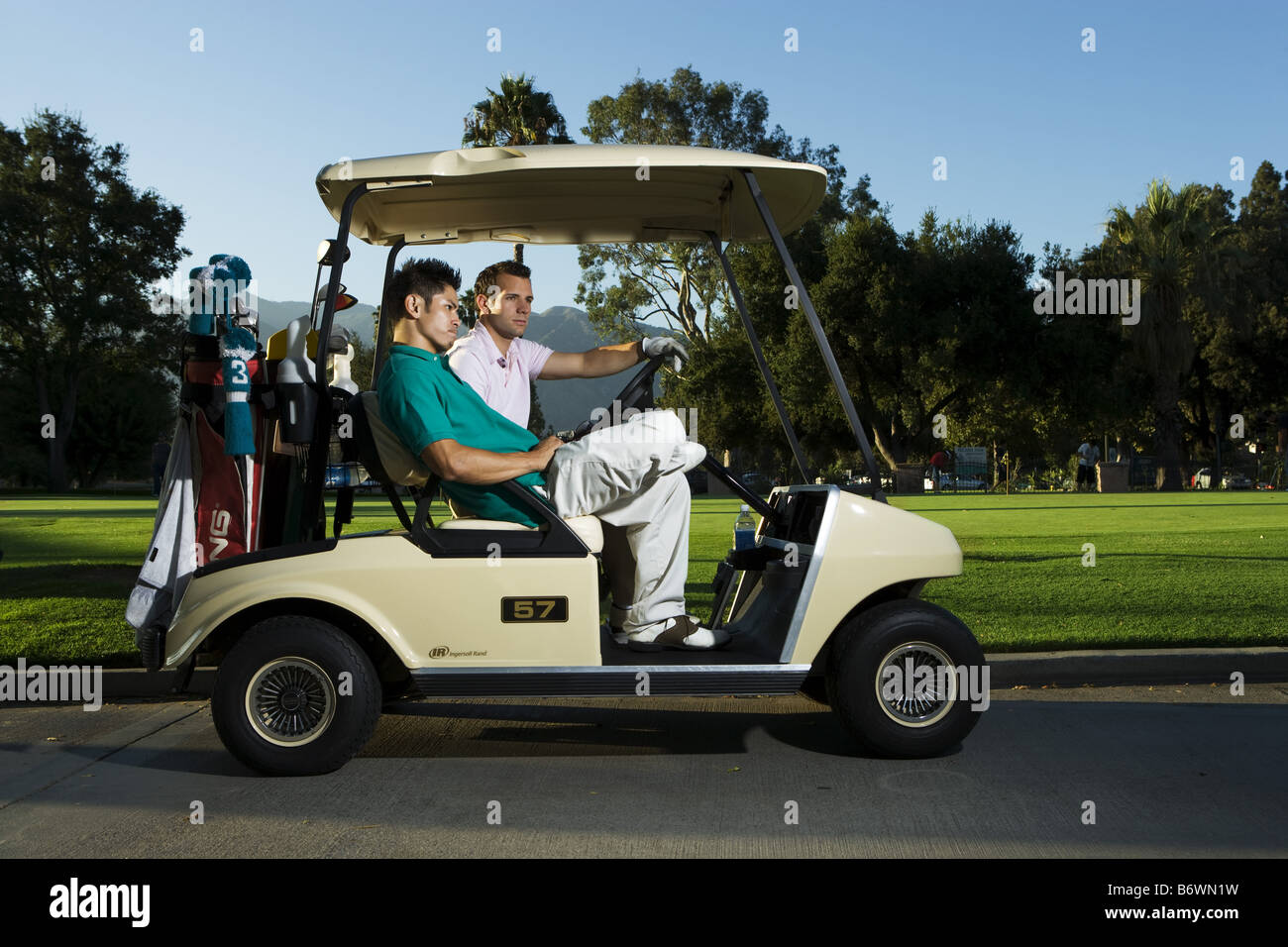 Two golfers on golf cart Stock Photo - Alamy