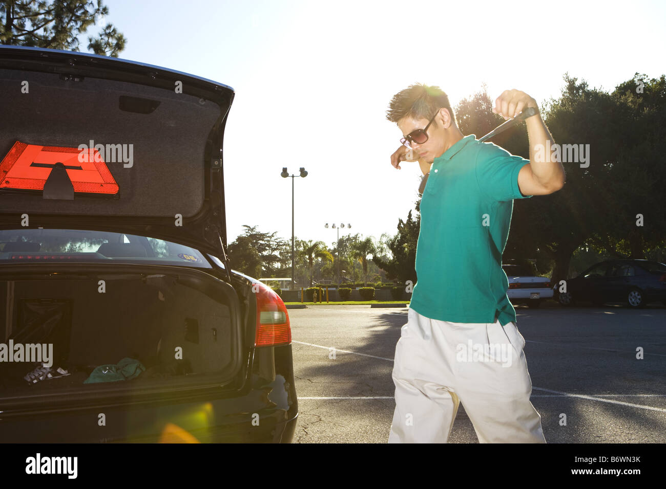 Golfer stretches with club across his back Stock Photo - Alamy